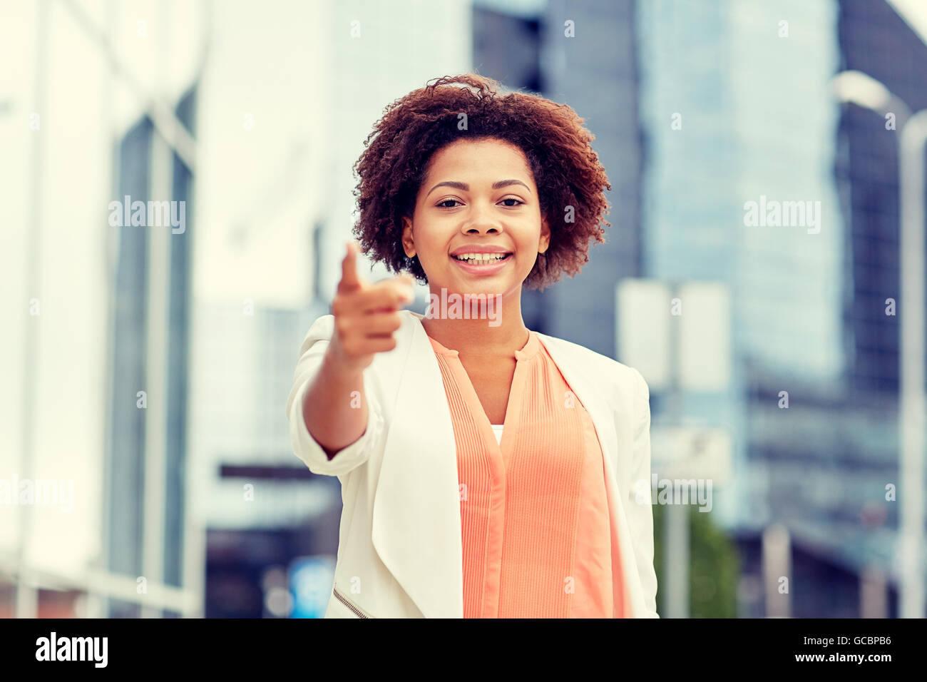 Happy african woman pointing finger hi-res stock photography and images ...