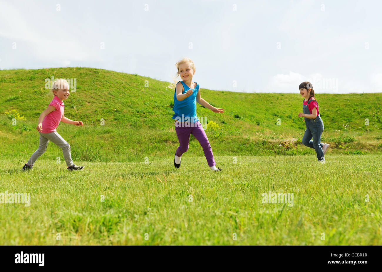 group of happy kids running outdoors Stock Photo - Alamy