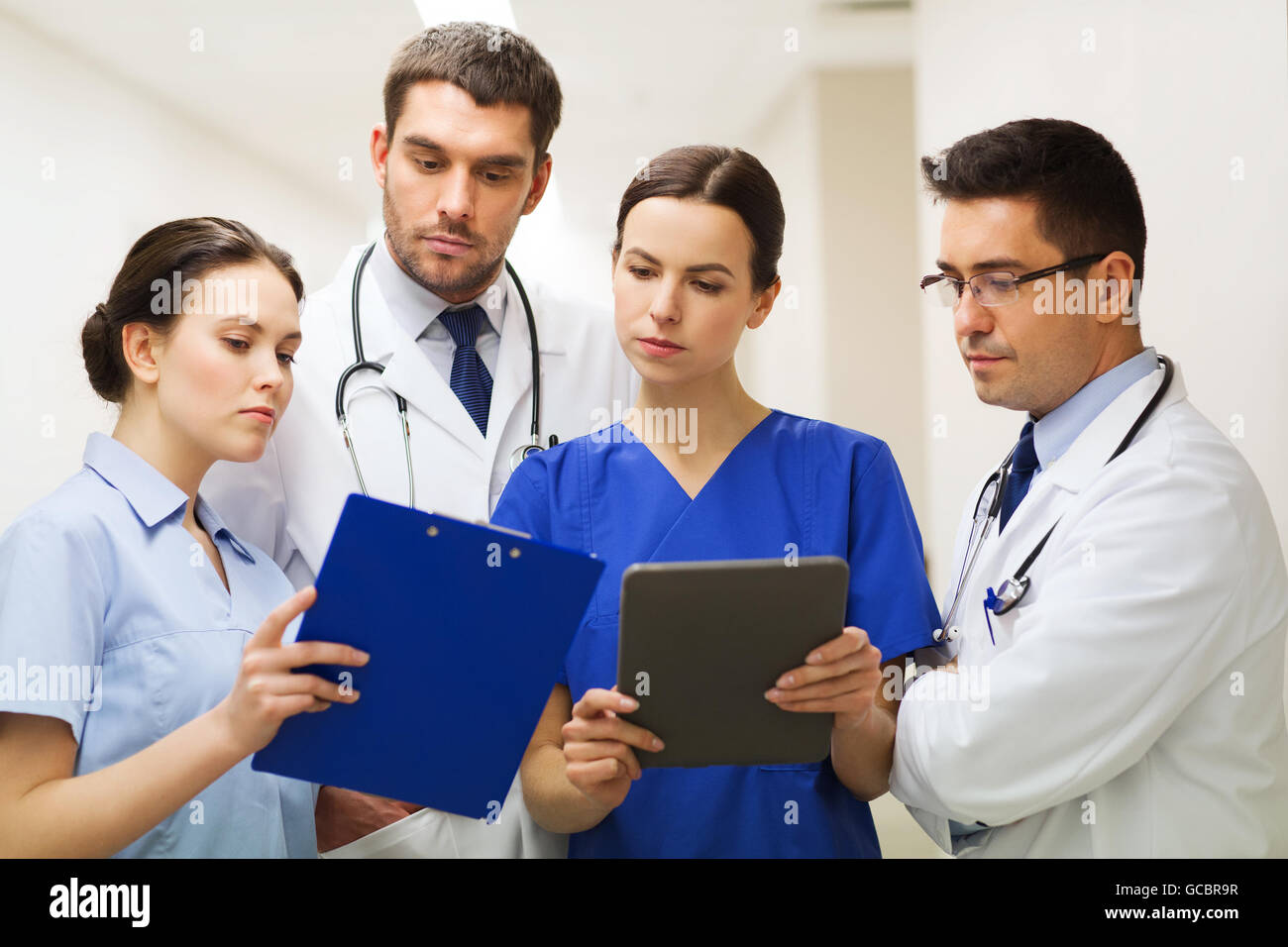 medics with clipboard and tablet pc at hospital Stock Photo - Alamy