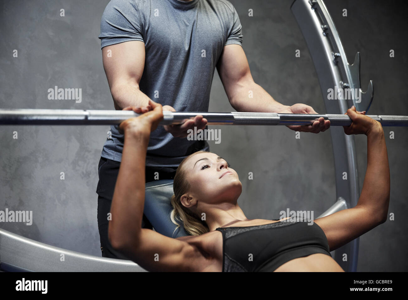 man and woman with barbell flexing muscles in gym Stock Photo - Alamy