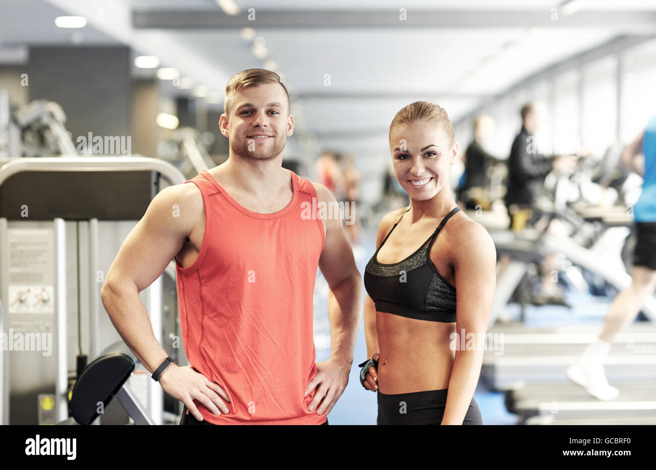 smiling man and woman in gym Stock Photo - Alamy
