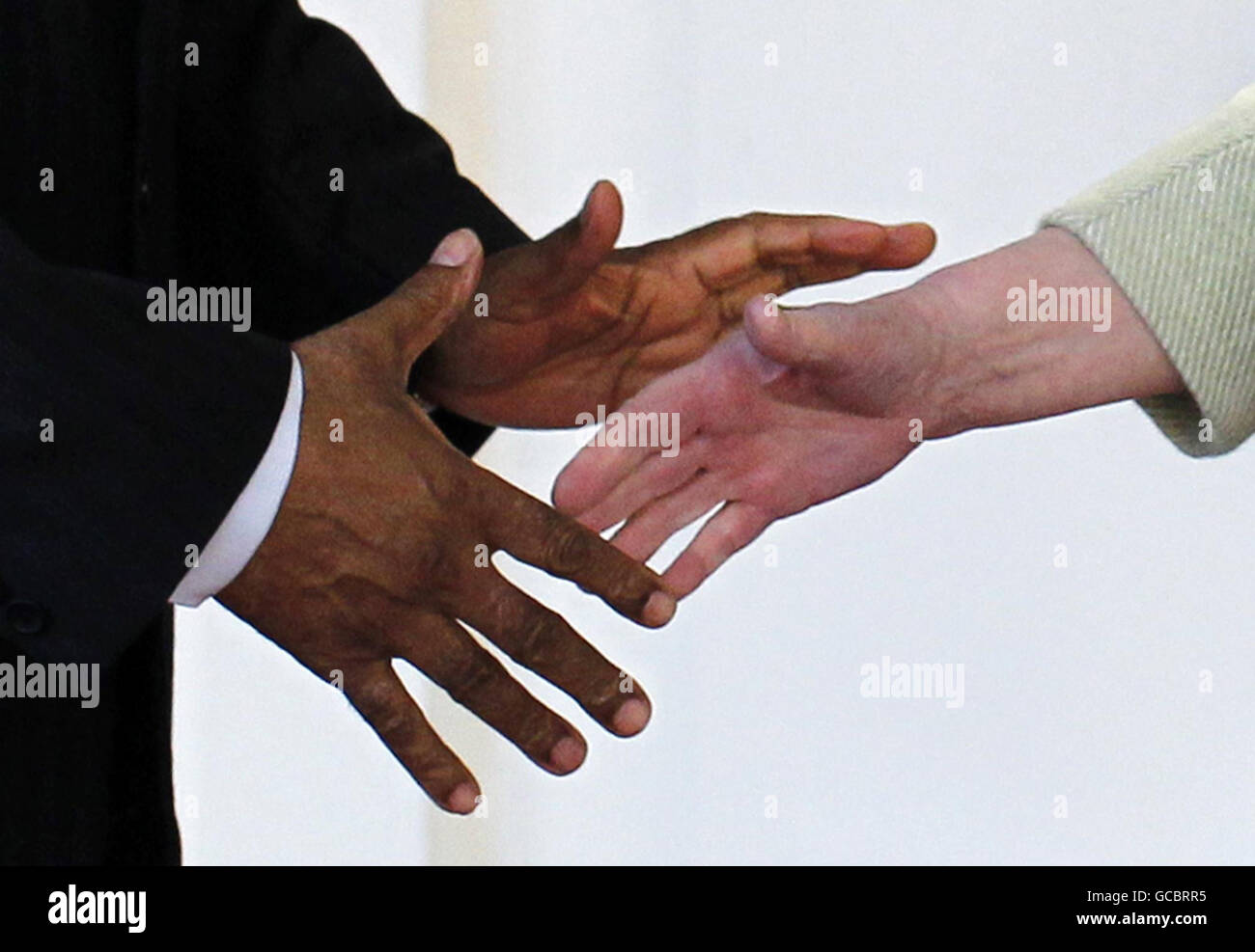 Britain's Queen Elizabeth II stretches out her hand as she bids ...