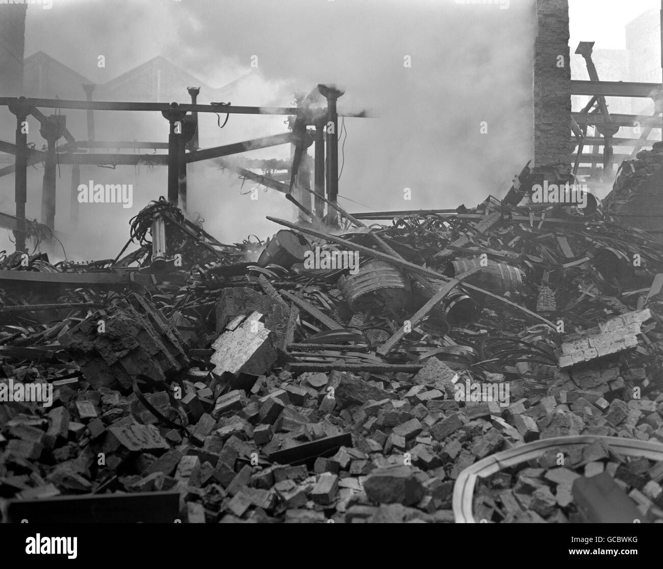 Tons of rubble and metal hoops from whisky barrels on the morning after ...