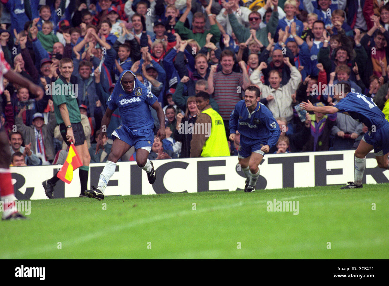 Chelsea's Frank Sinclair celebrates by pulling his shirt over his head ...