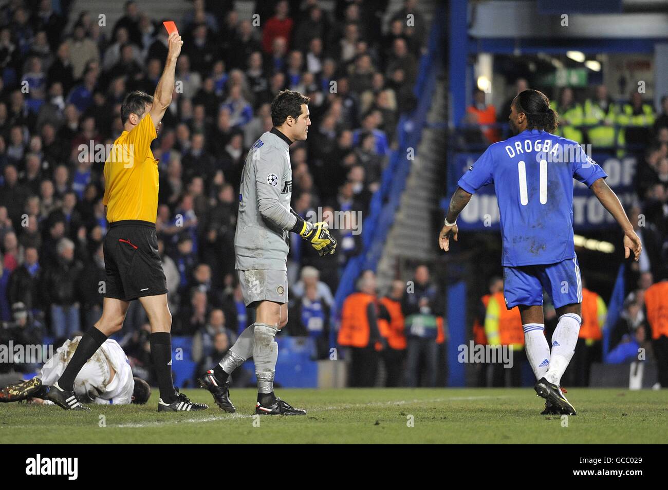 Referee Wolfgang Stark (left) shows Chelsea's Didier Drogba (right) the ...