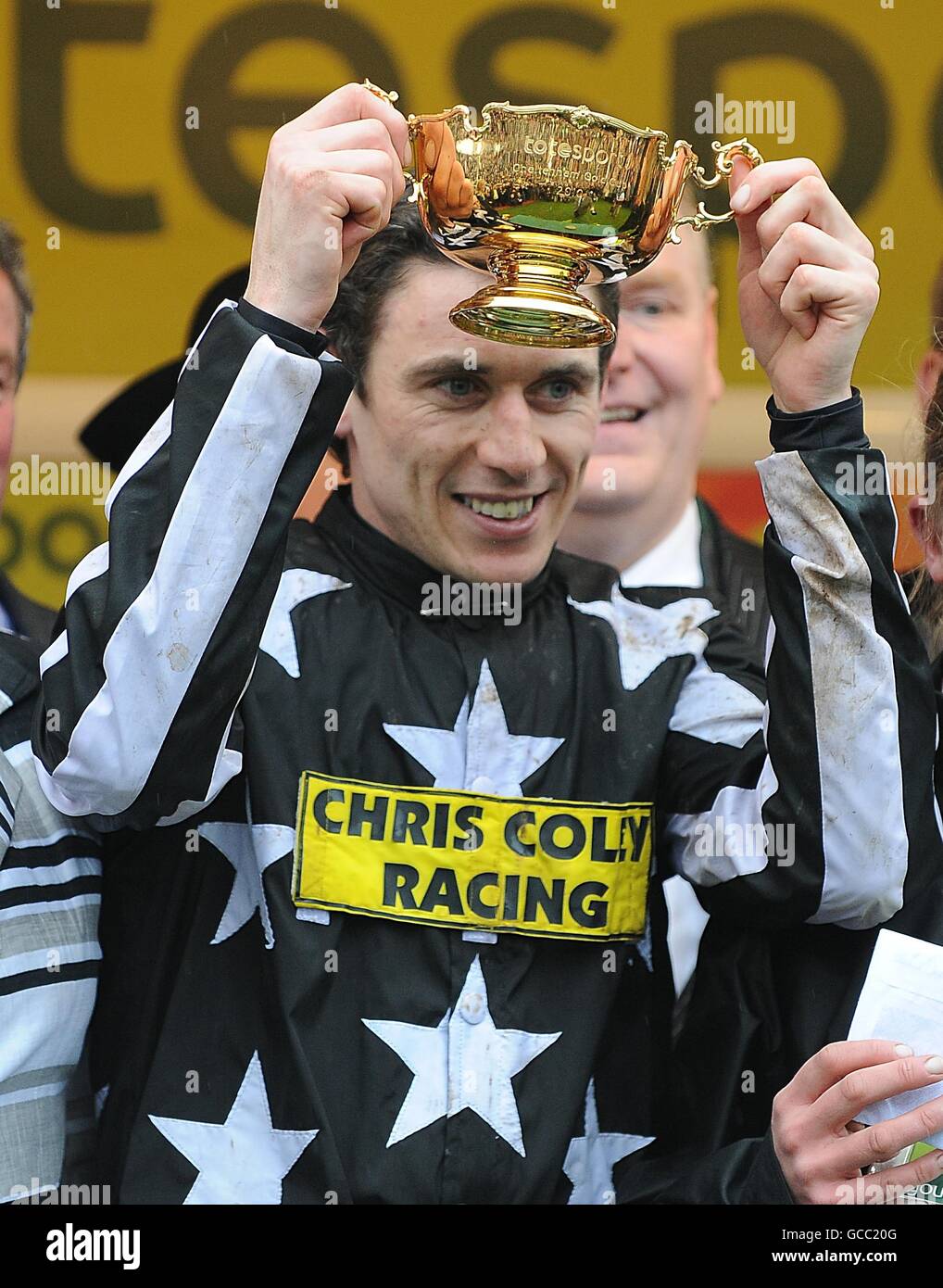 Jockey Paddy Brennan the gold cup trophy after winning the totesport ...