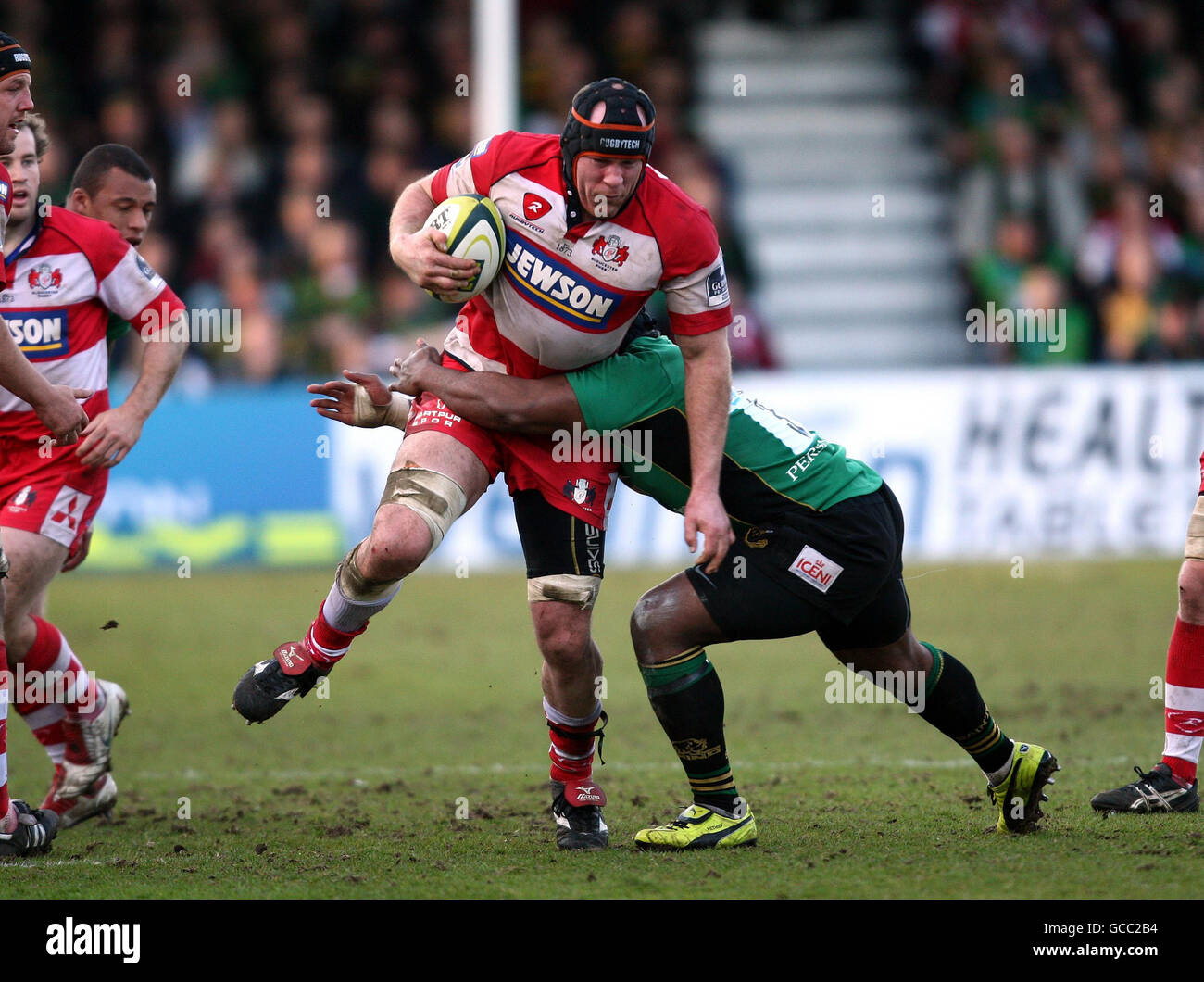 Gloucester's Peter Buxton is tackled by Northampton's Brian Mujati ...