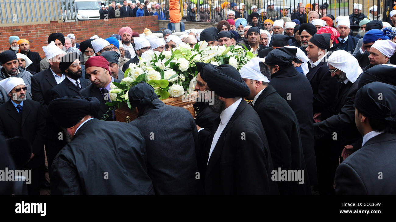 The coffin of shopkeeper Gurmail Singh is carried into the Sikh Temple in Huddersfield before ...