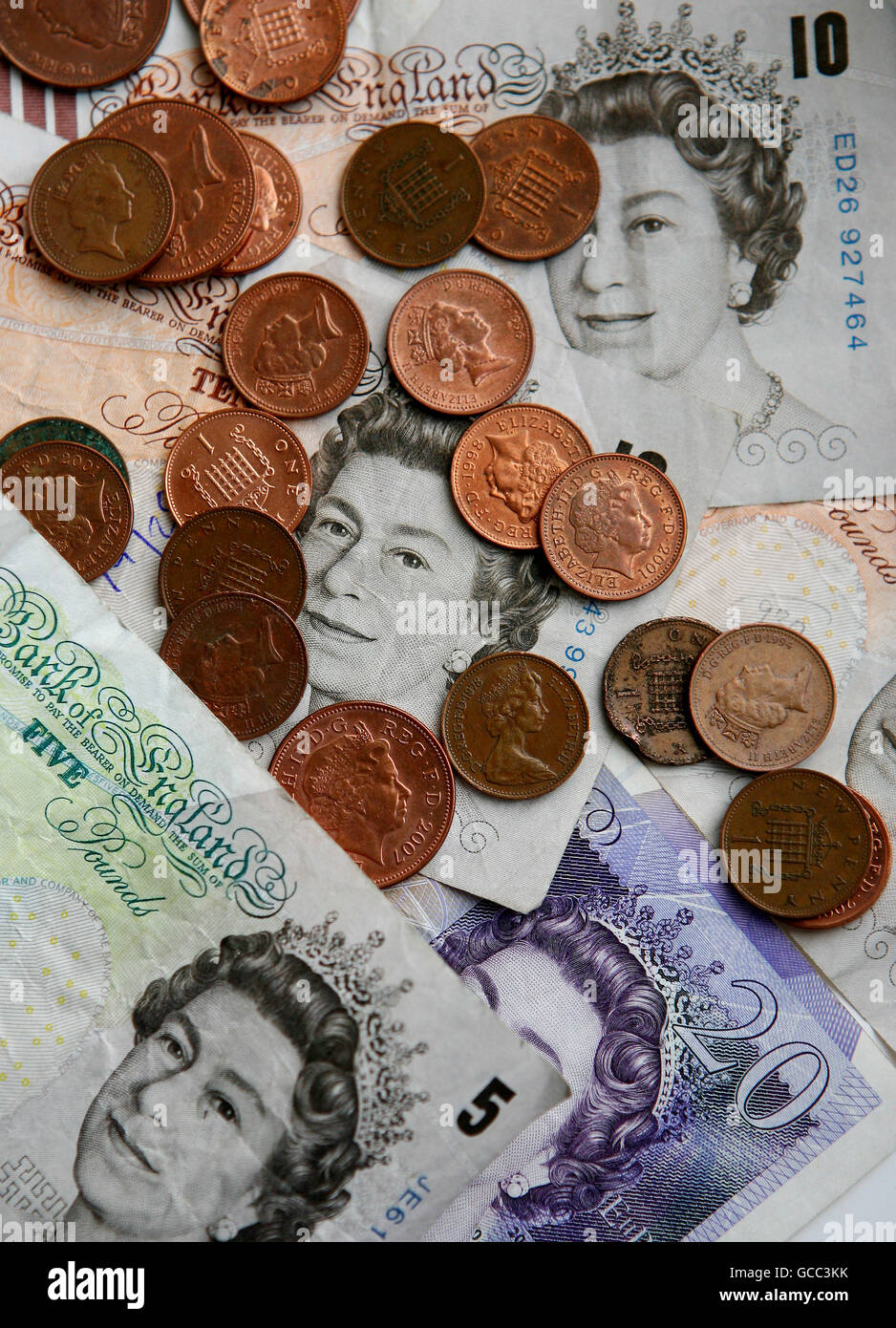 A close up view of five ten, and twenty pound notes with 1p and 2p ...