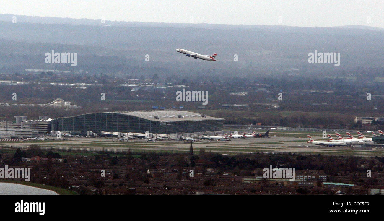 A British Airways plane takes off from Heathrow Airport as other BA ...