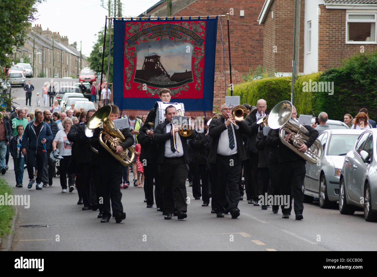 Greenside, UK, 9 July 2016. Drighlington Brass Band lead the pit banner ...