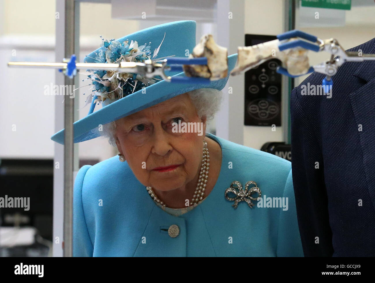 Queen Elizabeth II is shown bone which was cut using a saw, during a ...