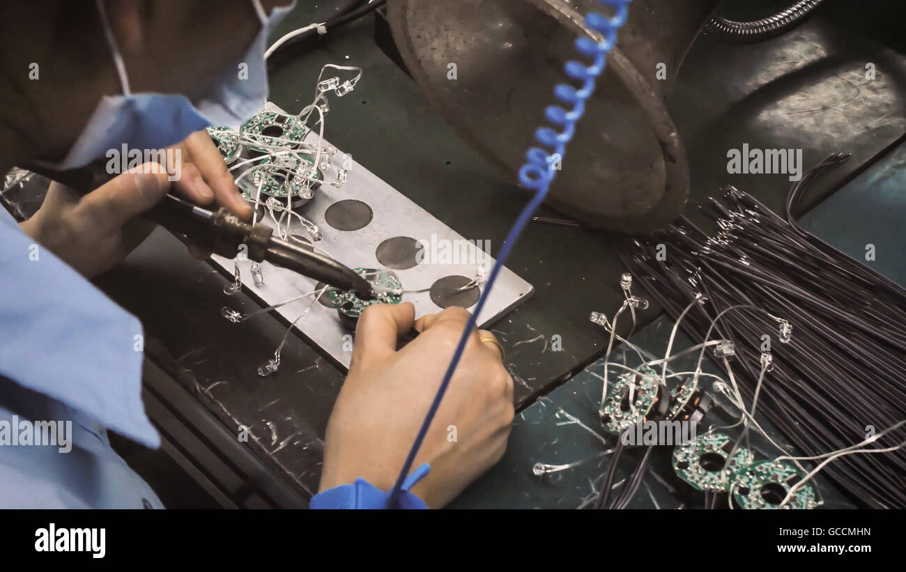 Soldering of electronic components in a factory of computer fans Stock ...