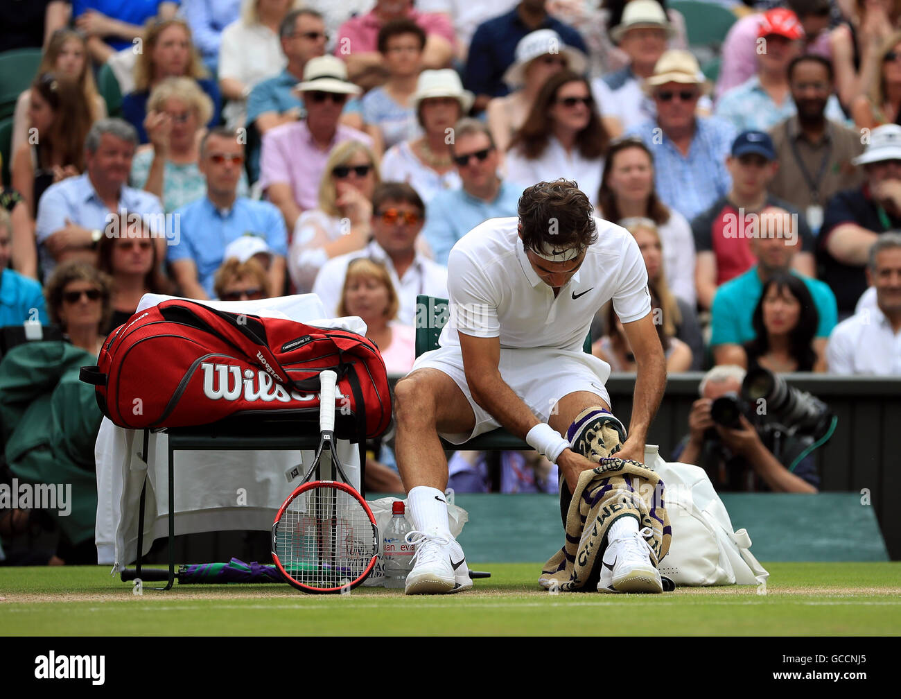 Roger Federer checks his leg after falling in the fifth set against ...