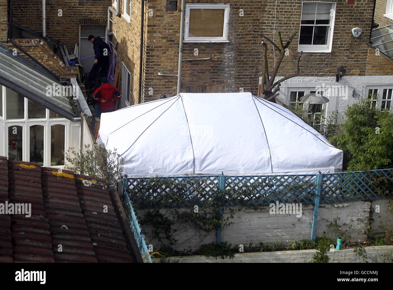 A police tent in the back garden of a house on Alderville Road, Fulham ...