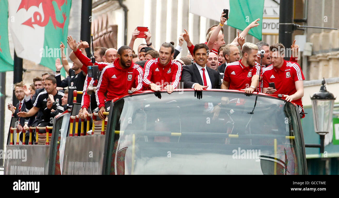 Wales players and manager Chris Coleman wave to fans on a open top bus ...