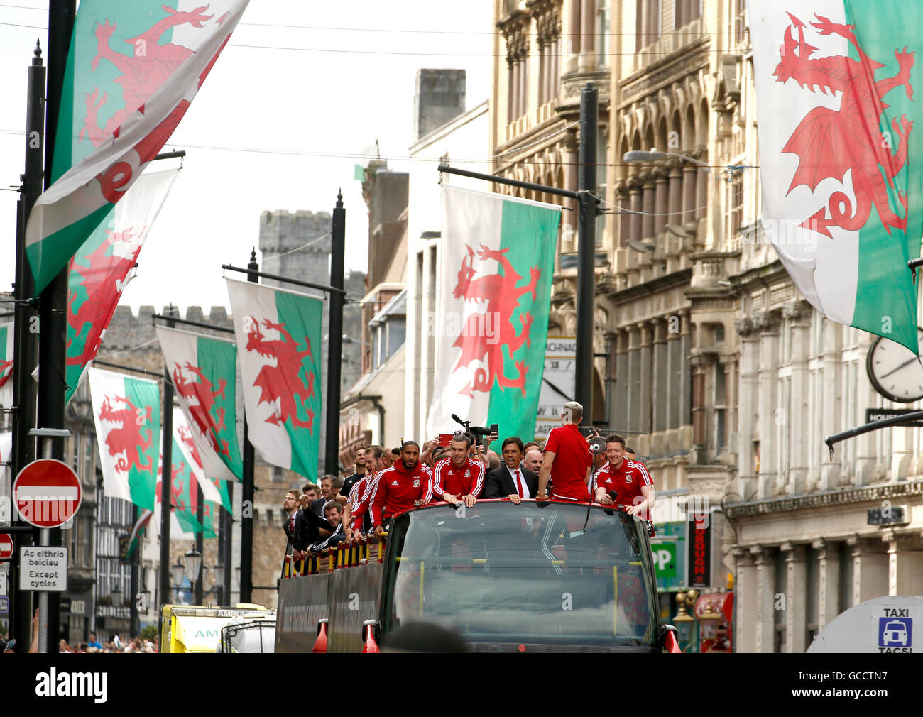 Wales players and manager Chris Coleman wave to fans on a open top bus ...