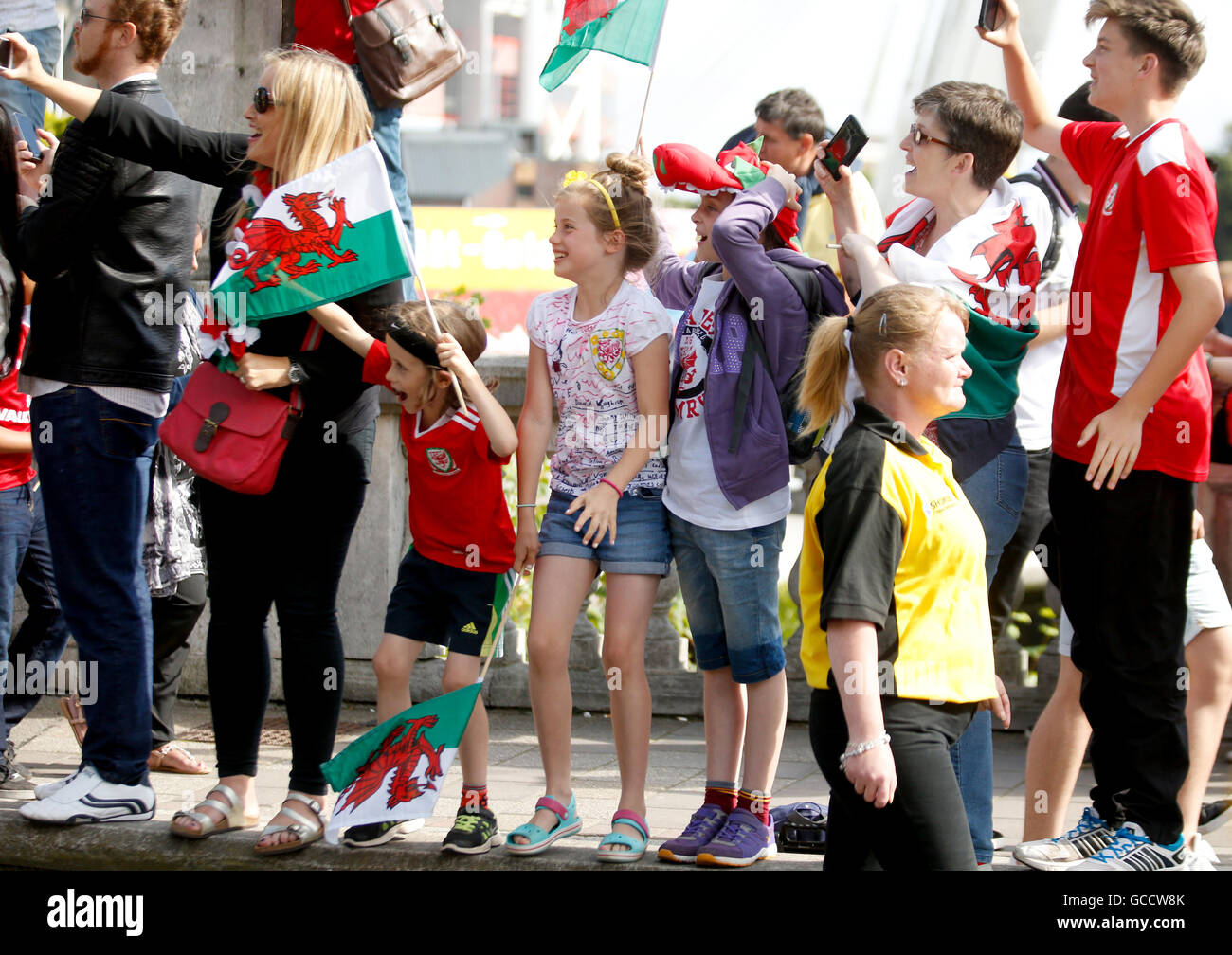 Spectators cheer on the Wales team during the open top bus homecoming ...