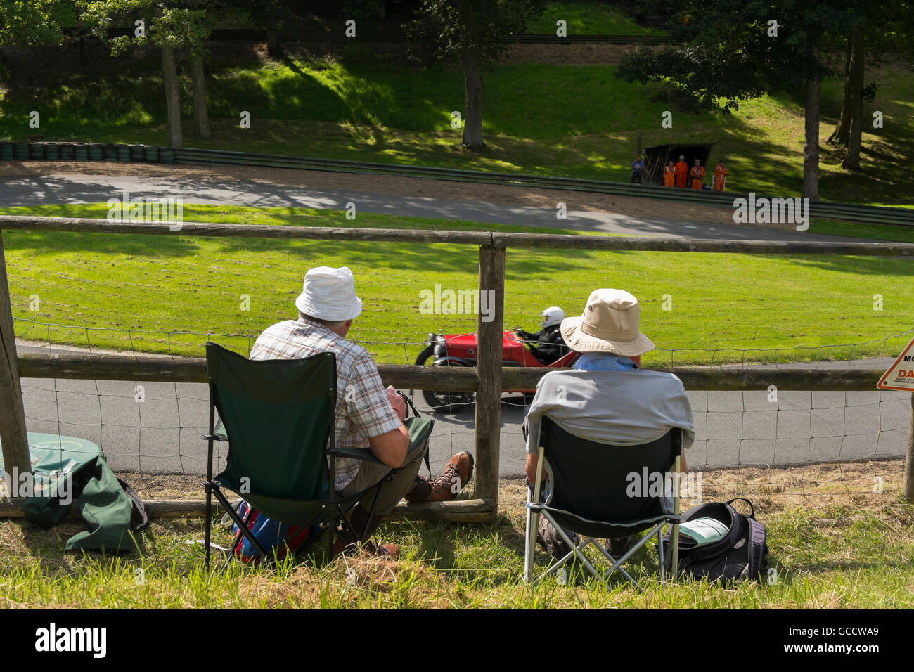 Spectators sitting on a foldaway chair watching the action at the VSCC ...