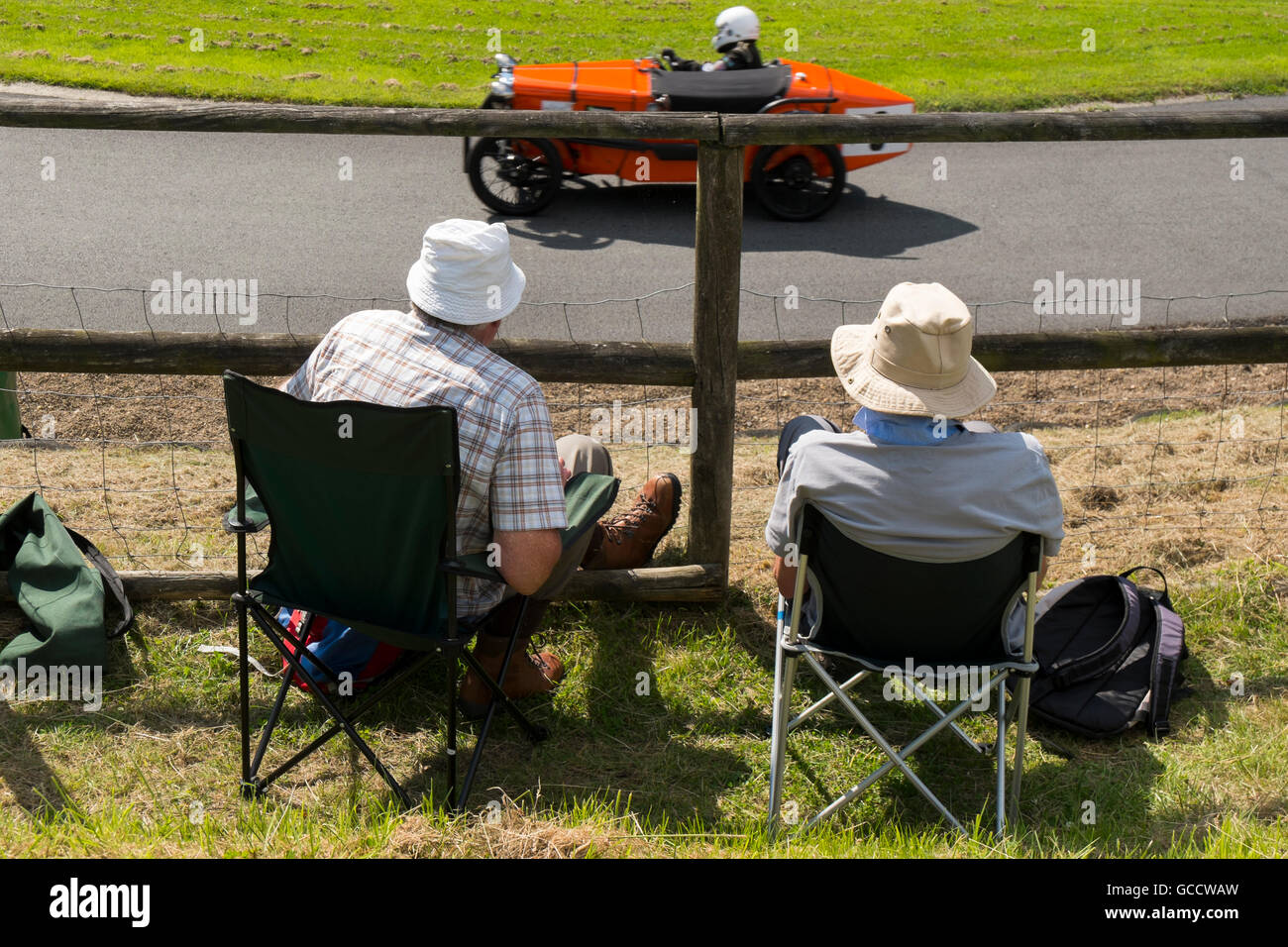 Spectators sitting on a foldaway chair watching the action at the VSCC ...
