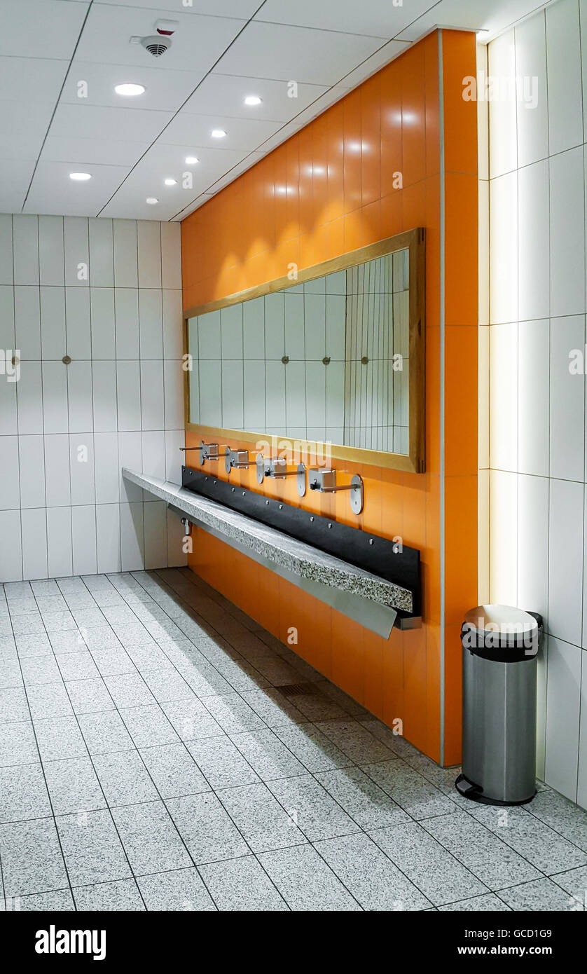 Public empty restroom with washstands mirror Stock Photo - Alamy