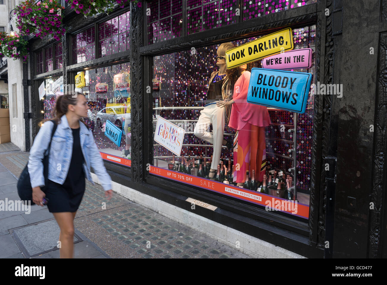 Street scene with person walking past Liberty window display of ...