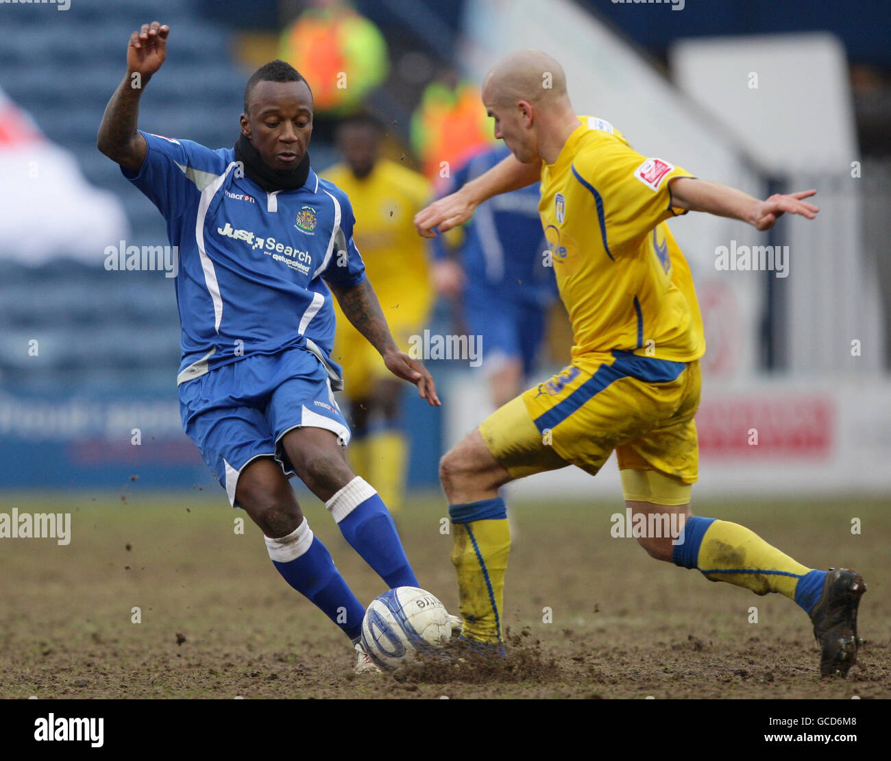 Colchester United's Marc Tierney (right) challenges Stockport County's ...