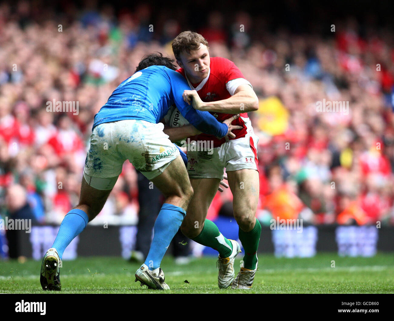 Wales' Tom Prydie is held by Italy's Luke Mclean during the RBS 6 ...