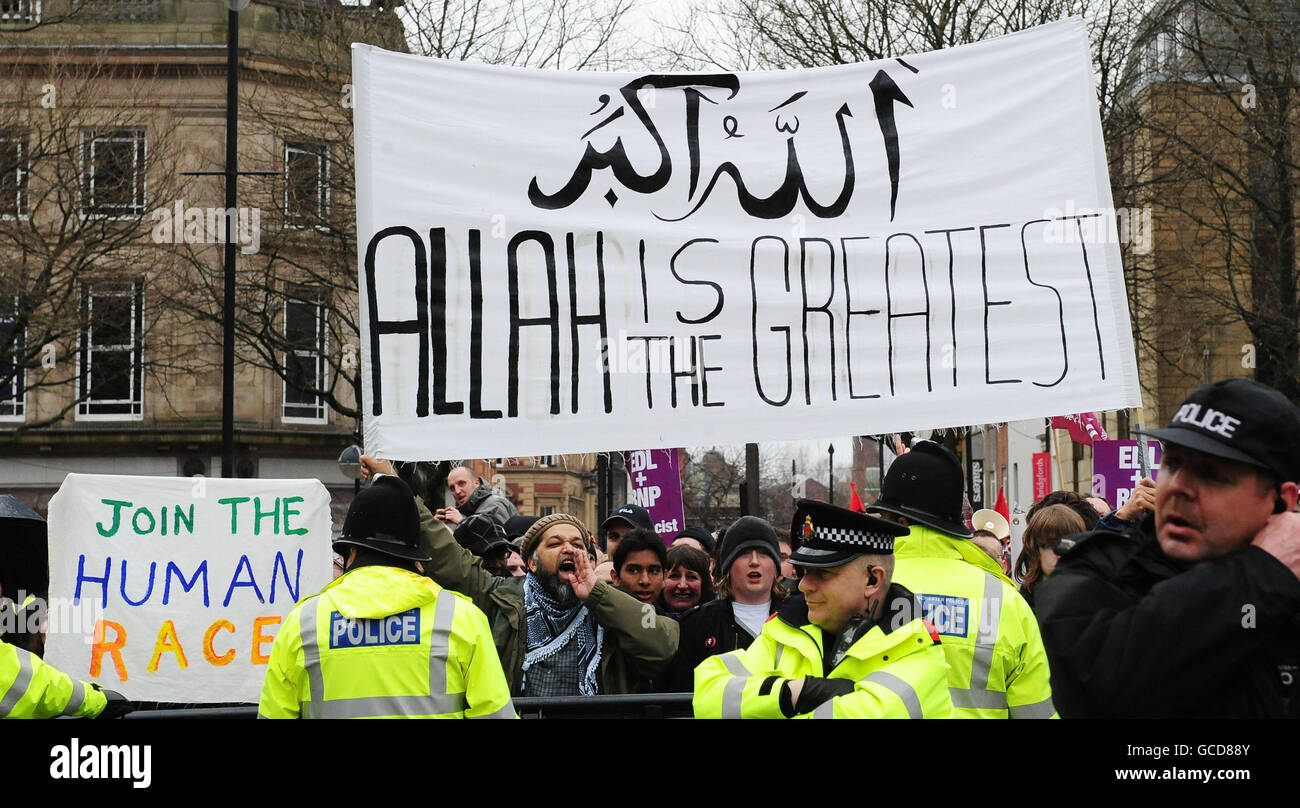 Supporters of the Unite Against Fascism group, carry a banner during a ...