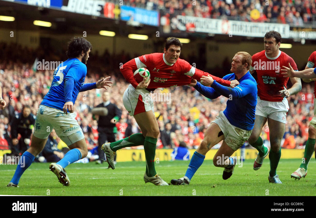 Wales' James Hook (centre) is held by Italy's Gonzalo Garcia during the ...