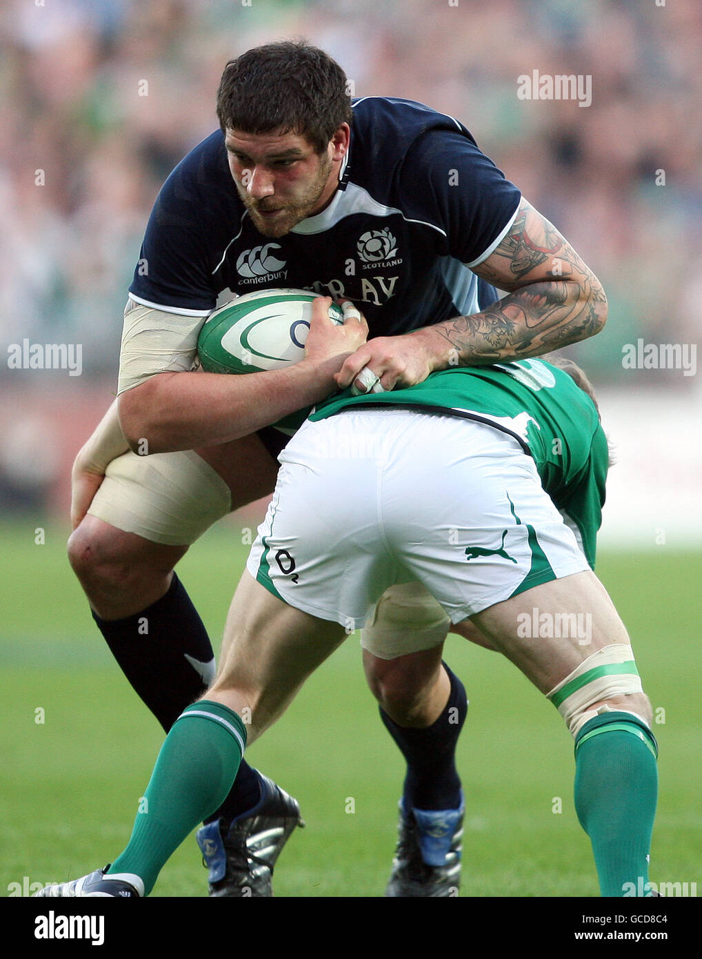 Irelands brian odriscoll tackles scotlands jim hamilton hi-res stock ...
