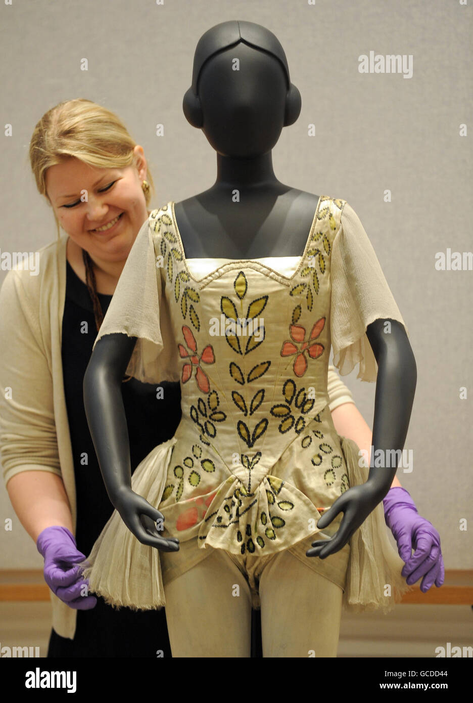 A member of staff adjusts a costume worn by Alice Nikitina in Zephyr et ...