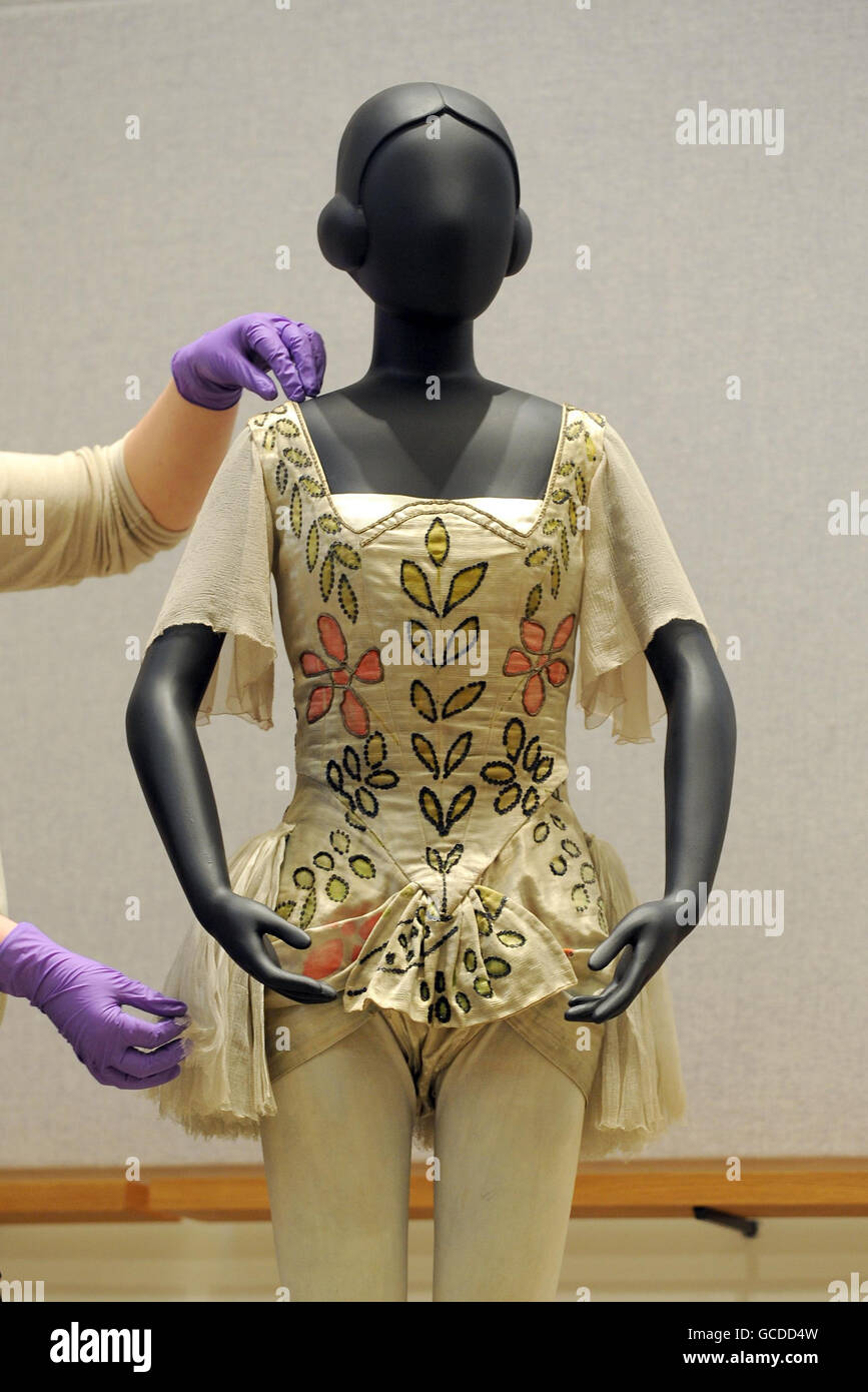 A member of staff adjusts a costume designed by George Braque and worn ...