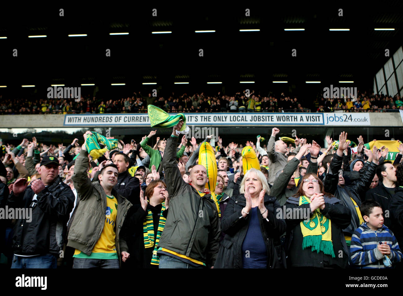 Norwich city fans cheer on their side in the stands hi-res stock ...