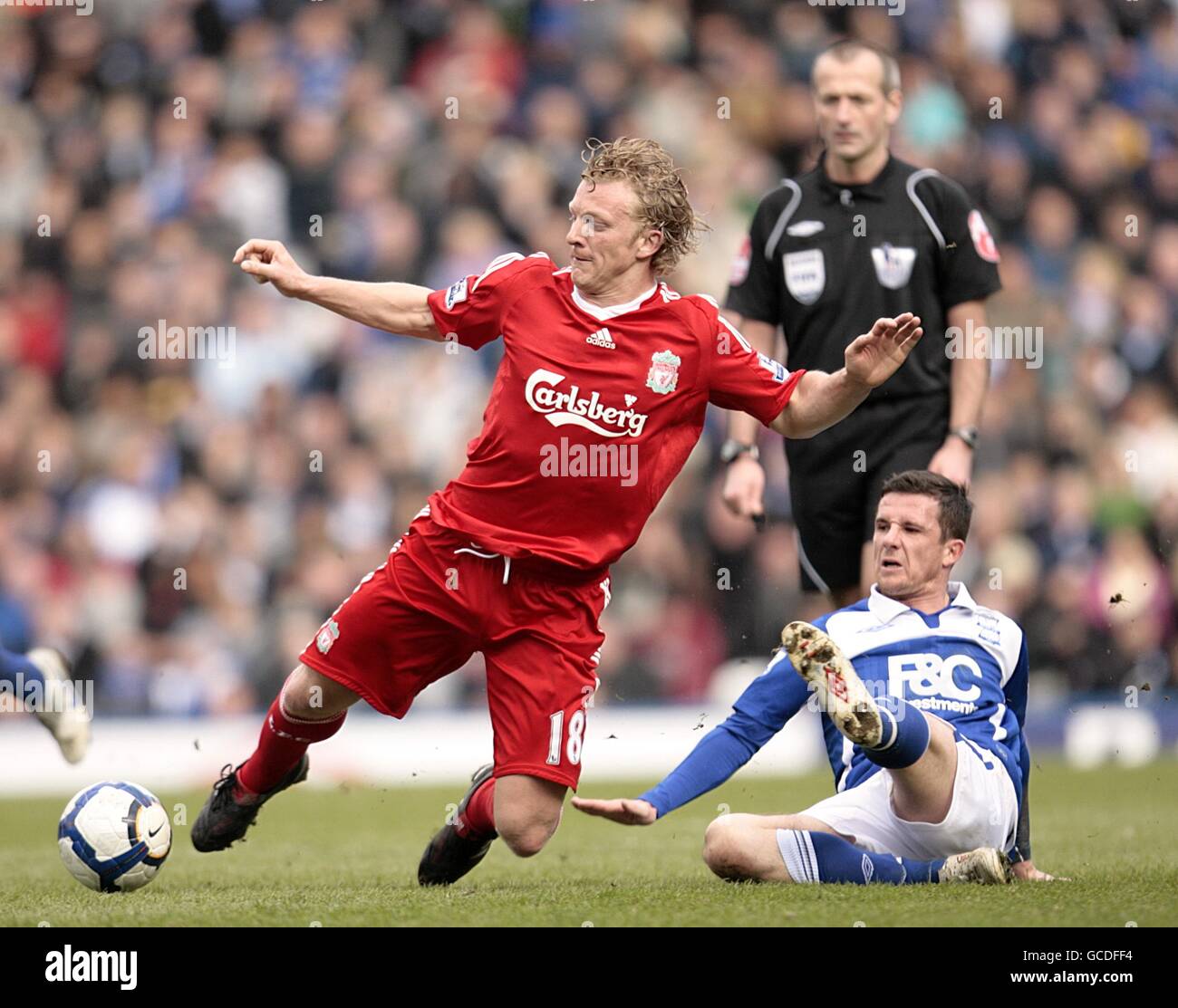 Liverpool's Dirk Kuyt (left) is fouled by Birmingham City's Barry ...