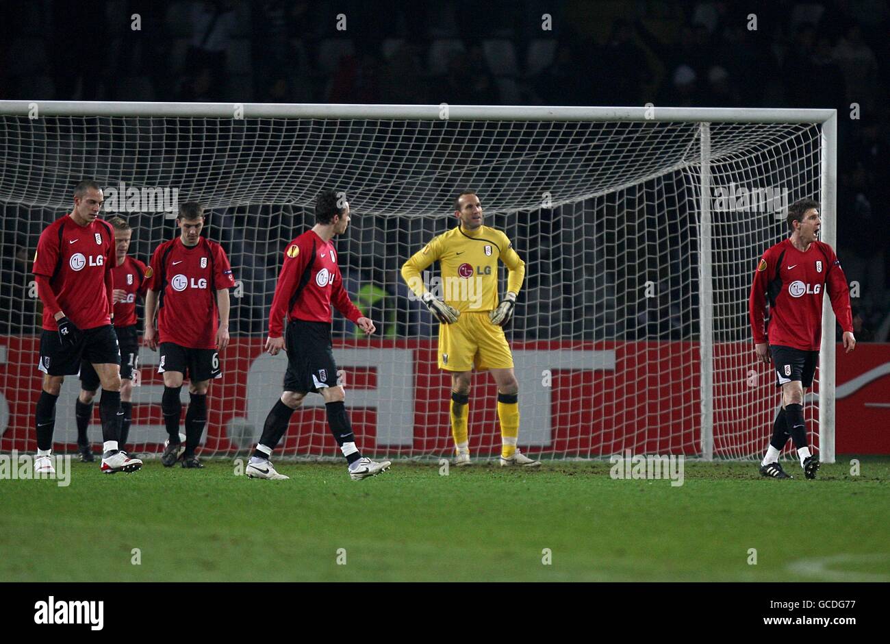 Fulham goalkeeper Mark Schwarzer (2nd right) and his team mates stand ...
