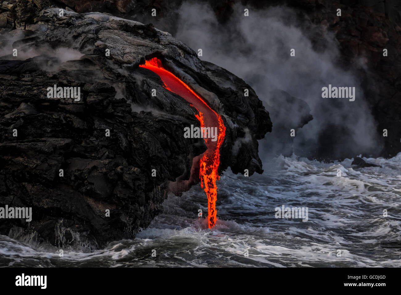 Glowing red lava flowing into the ocean; Island of Hawaii, Hawaii ...