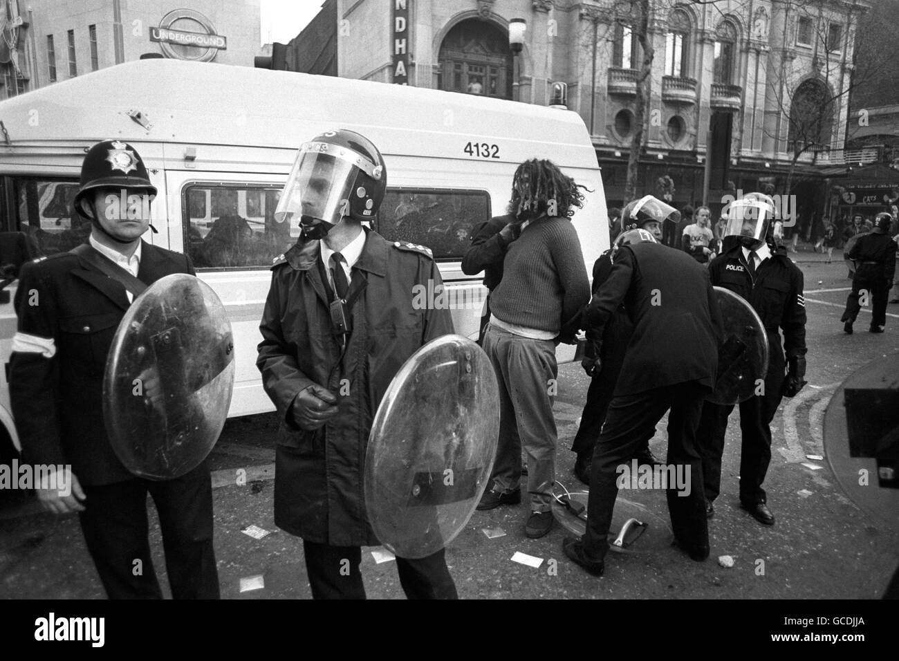 Riot police arresting a man during an anti-poll tax demonstration which ...
