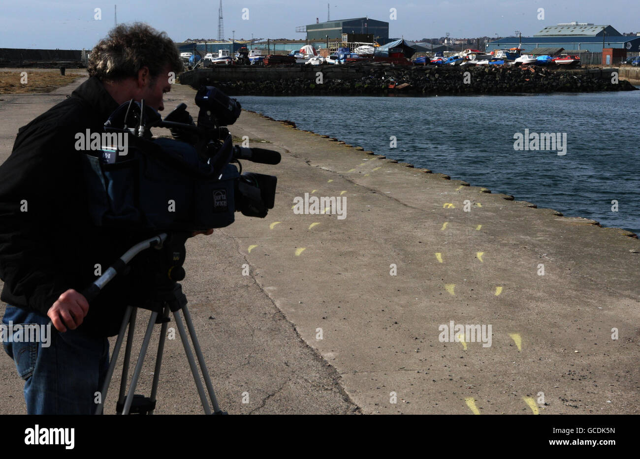 A cameraman films yellow markings on the dockside of Methil Docks in ...