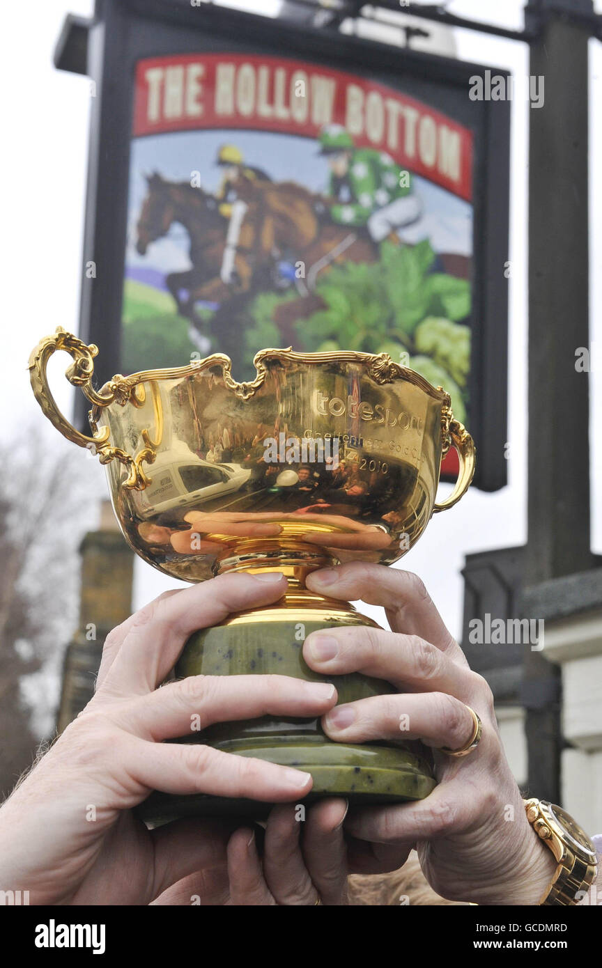 The Cheltenham Gold Cup is held aloft during the victory parade outside ...