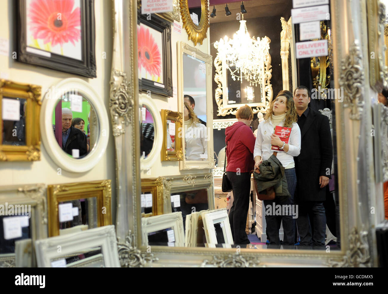 Couple looking mirrors on display ideal home show earls court hi-res ...