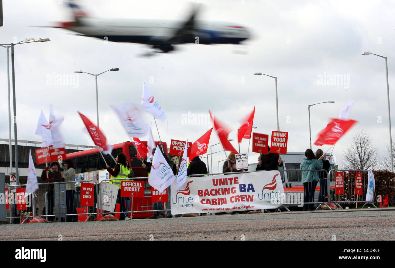 A British Airways plane flies over a picket line near Hatton Cross, as ...