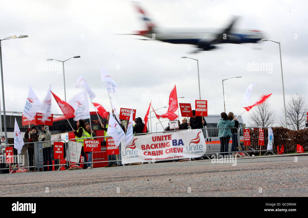 A British Airways plane flies over a picket line near Hatton Cross, as ...