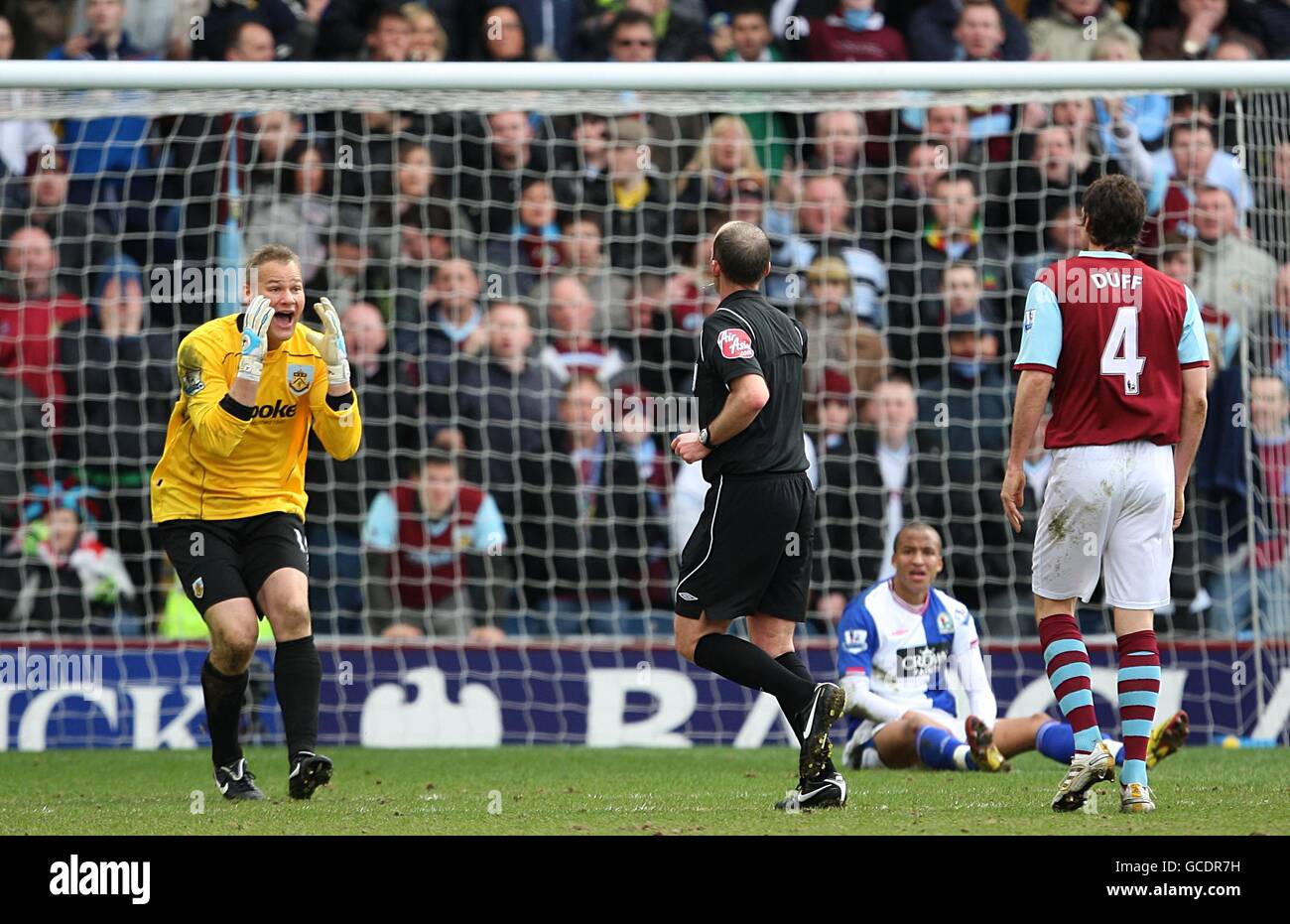 Burnley goalkeeper Brian Jensen (left) looks in disbelief as referee ...