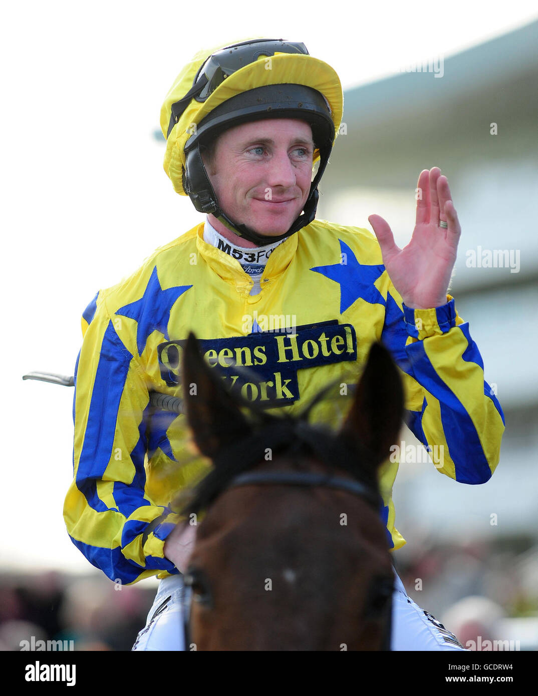 Jockey Paul Hanagan waves to the crowd after winning the williamhill ...