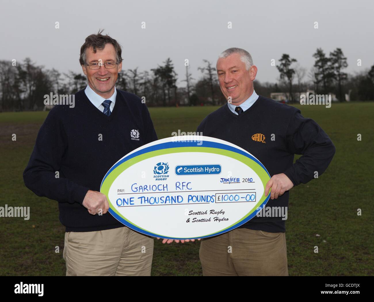 Paddy Hart from the SRU (left) handing the cheque to Garioch club ...