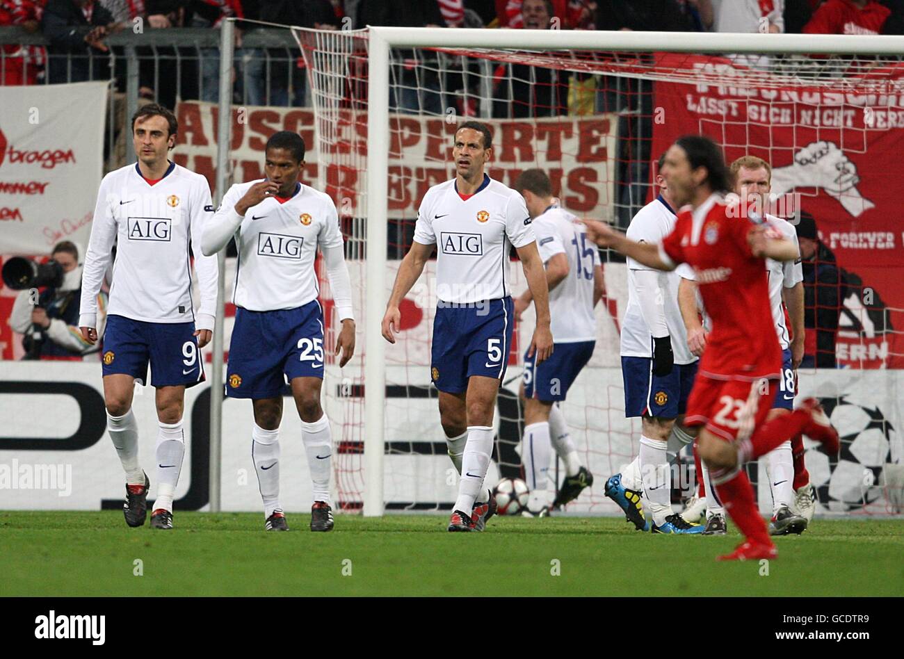 Manchester United players walk back dejected after Bayern Munich's ...