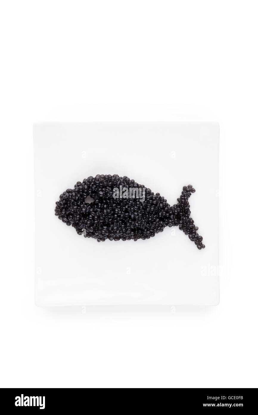 Delicious black caviar in fish shape isolated on white background ...