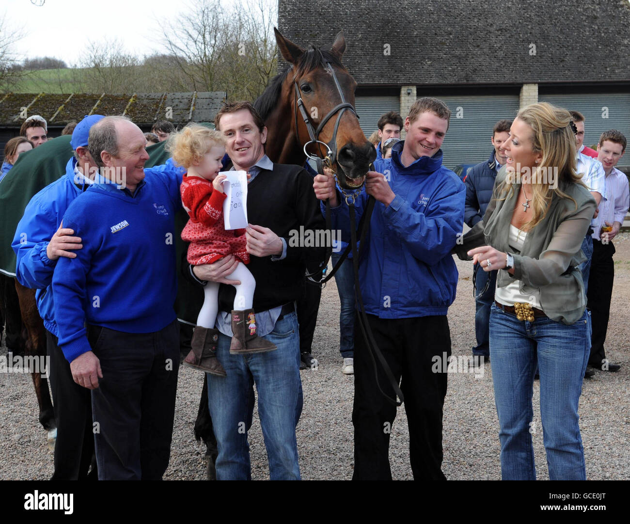 Jockey Tony McCoy holds his daughter Eve aged 2, alongside Don't Push ...