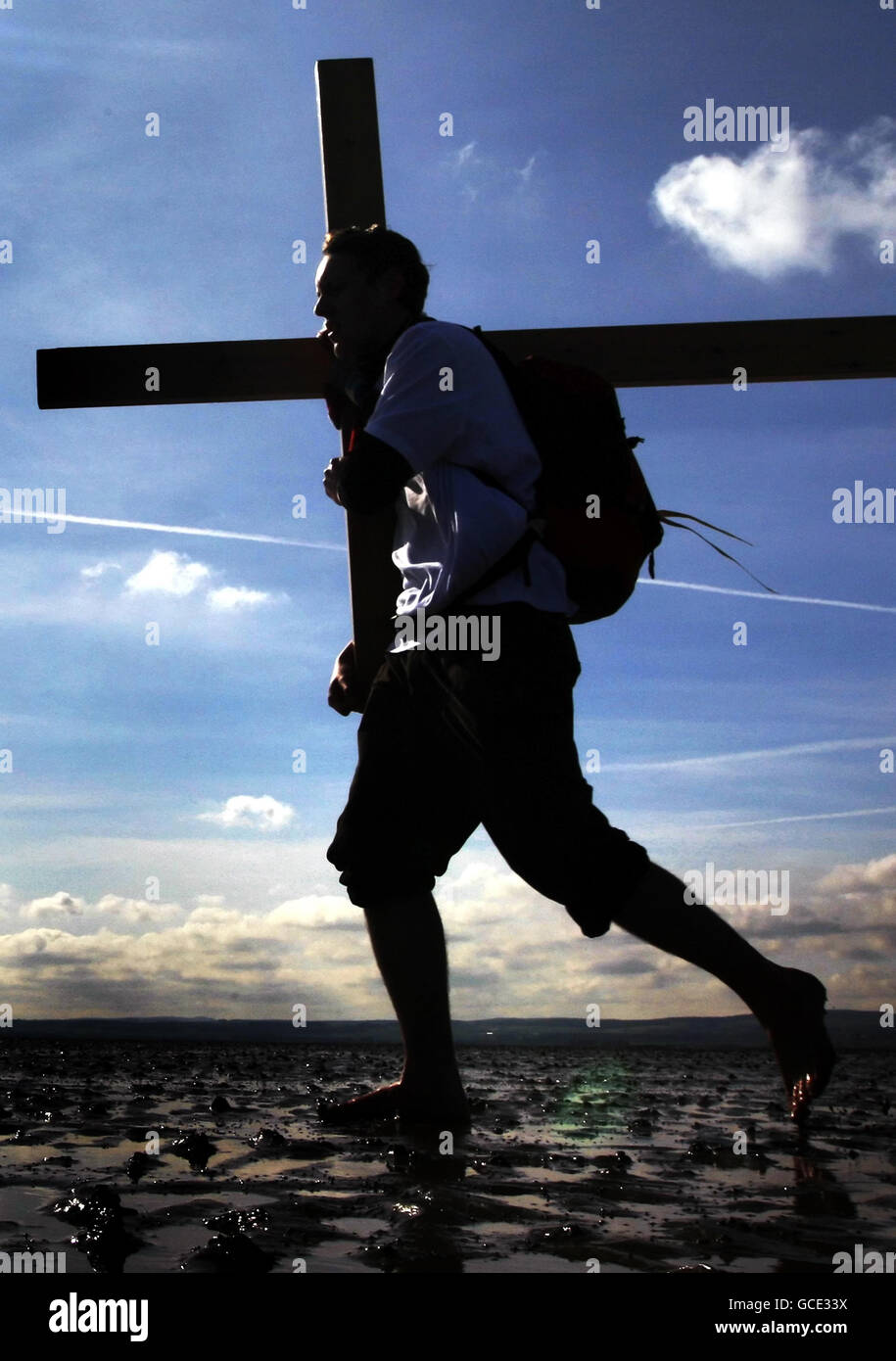 A pilgrim walks with a cross on the final leg of the Northern Cross ...